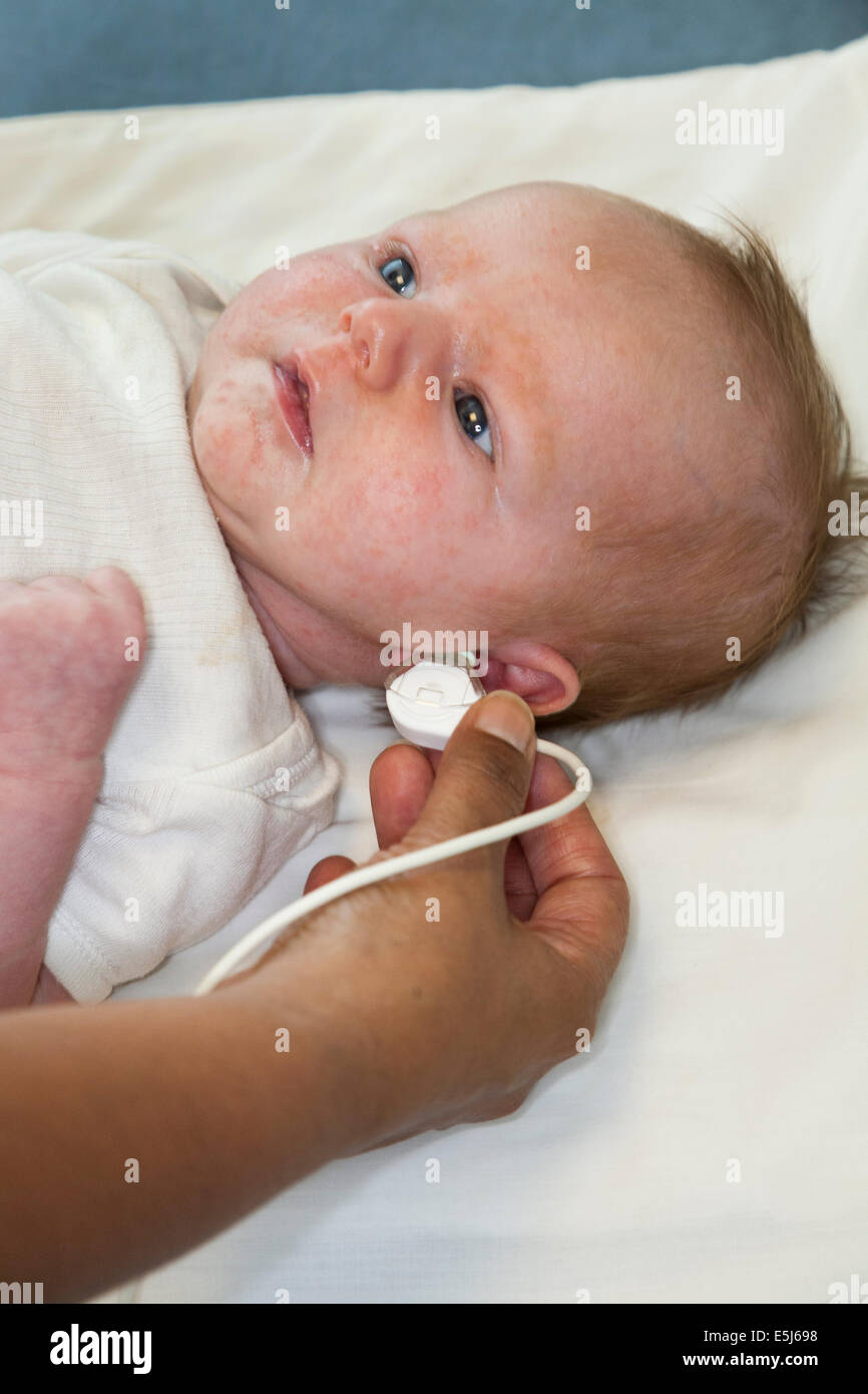 Newborn / new born baby undergoes a neonatal hearing screening test ...