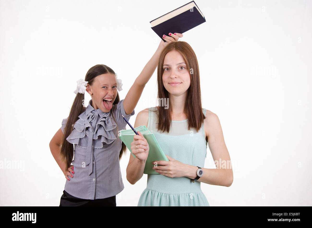 Trainee teacher mocks trying to hit her over the head with a book Stock ...