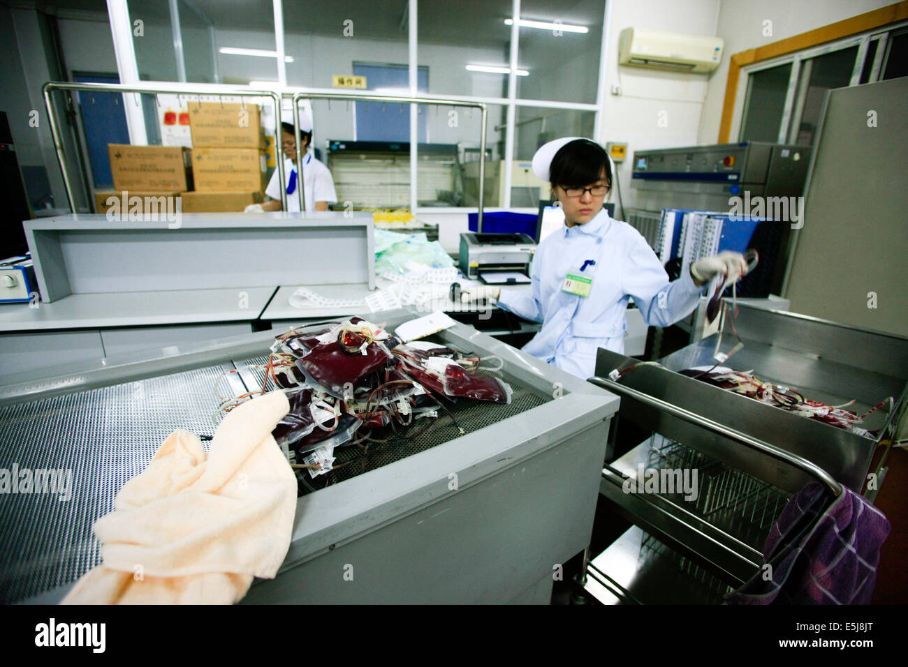 Kunshan, China's Jiangsu province. 2nd Aug, 2014. Staff members of ...