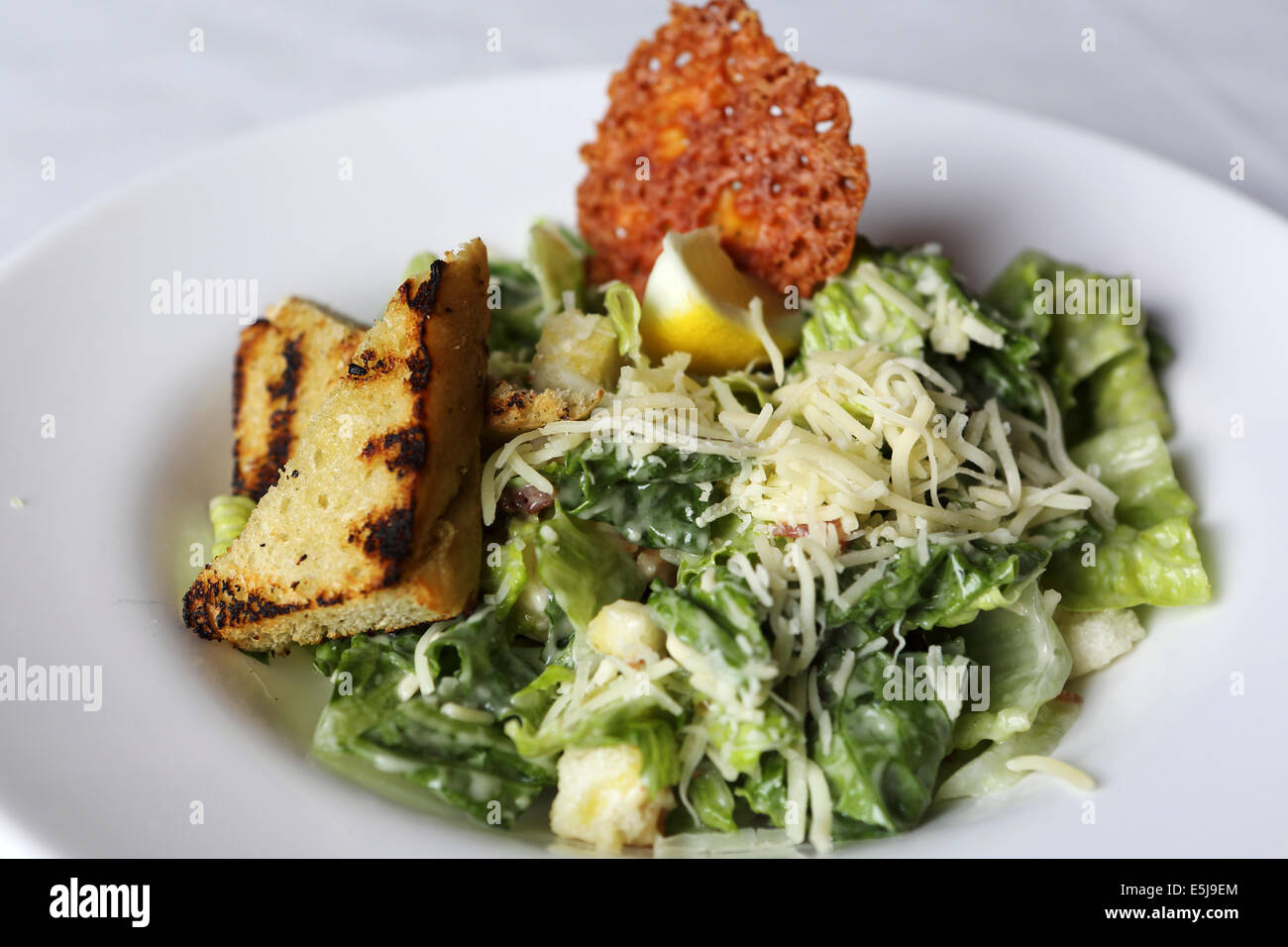 A Caesar Salad with cheese and toasted bread Stock Photo - Alamy
