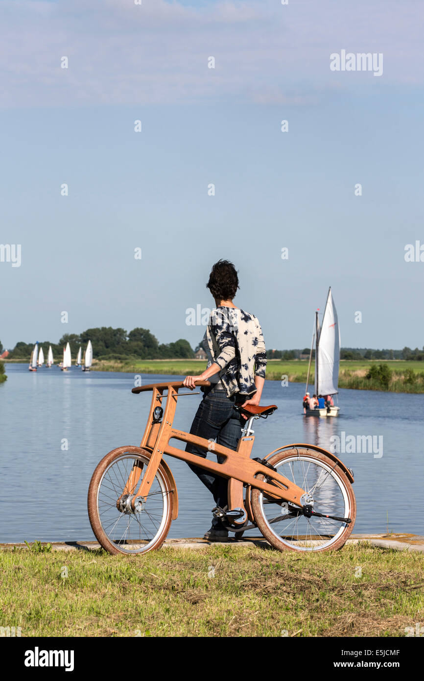 Netherlands, Woudsend, Woman sitting next to a Bough Bike. The Dutch ...