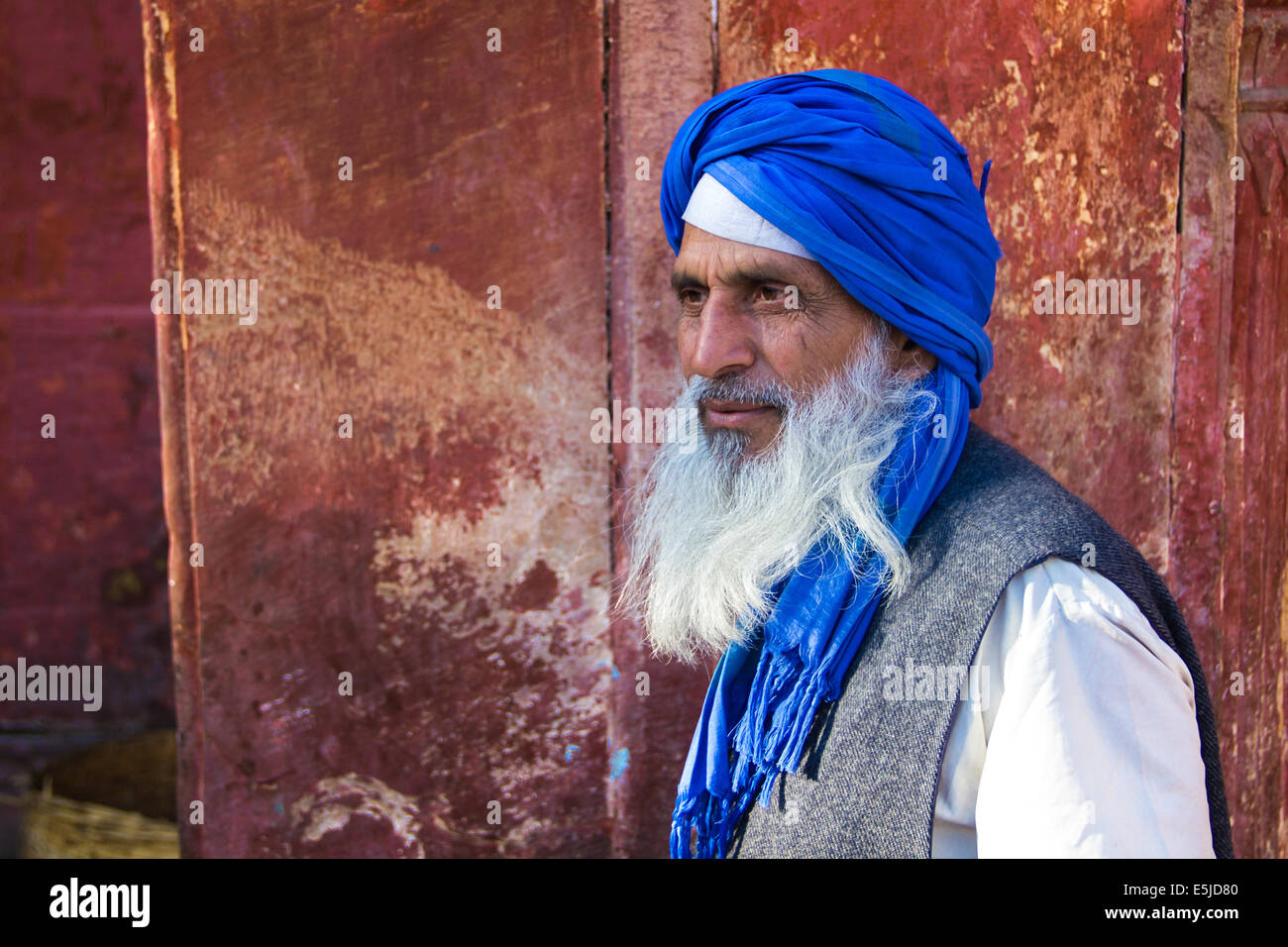 A muslim man with a blue turban and a white beard at a mosque in the ...