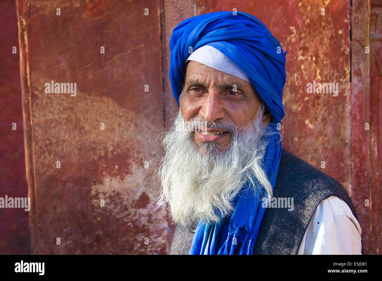 A muslim man with a blue turban and a white beard at a mosque in the ...