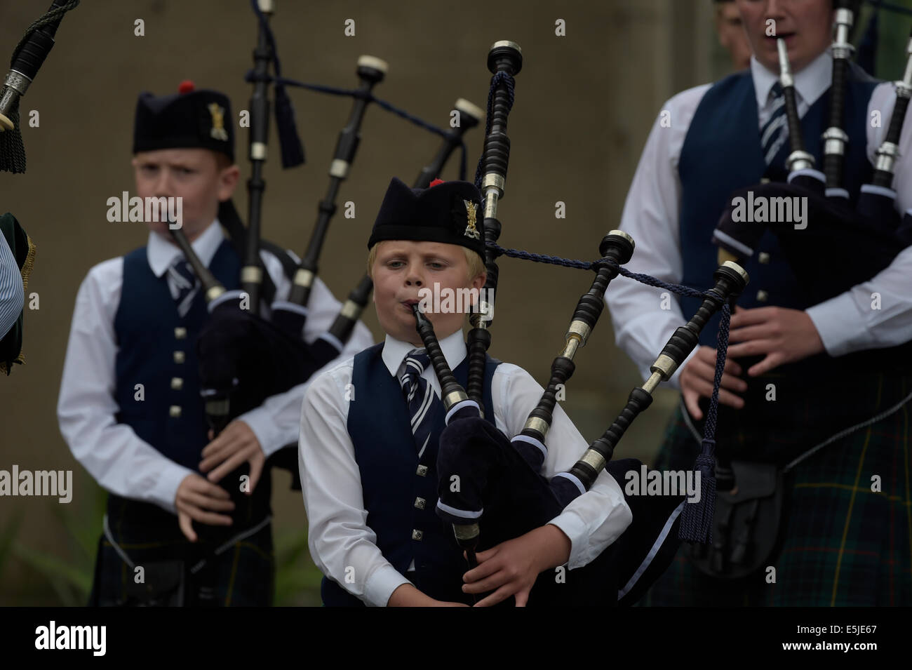 Melrose, UK. 02 Aug 2014. Melrose Pipe Band C/Ships A young piper ...