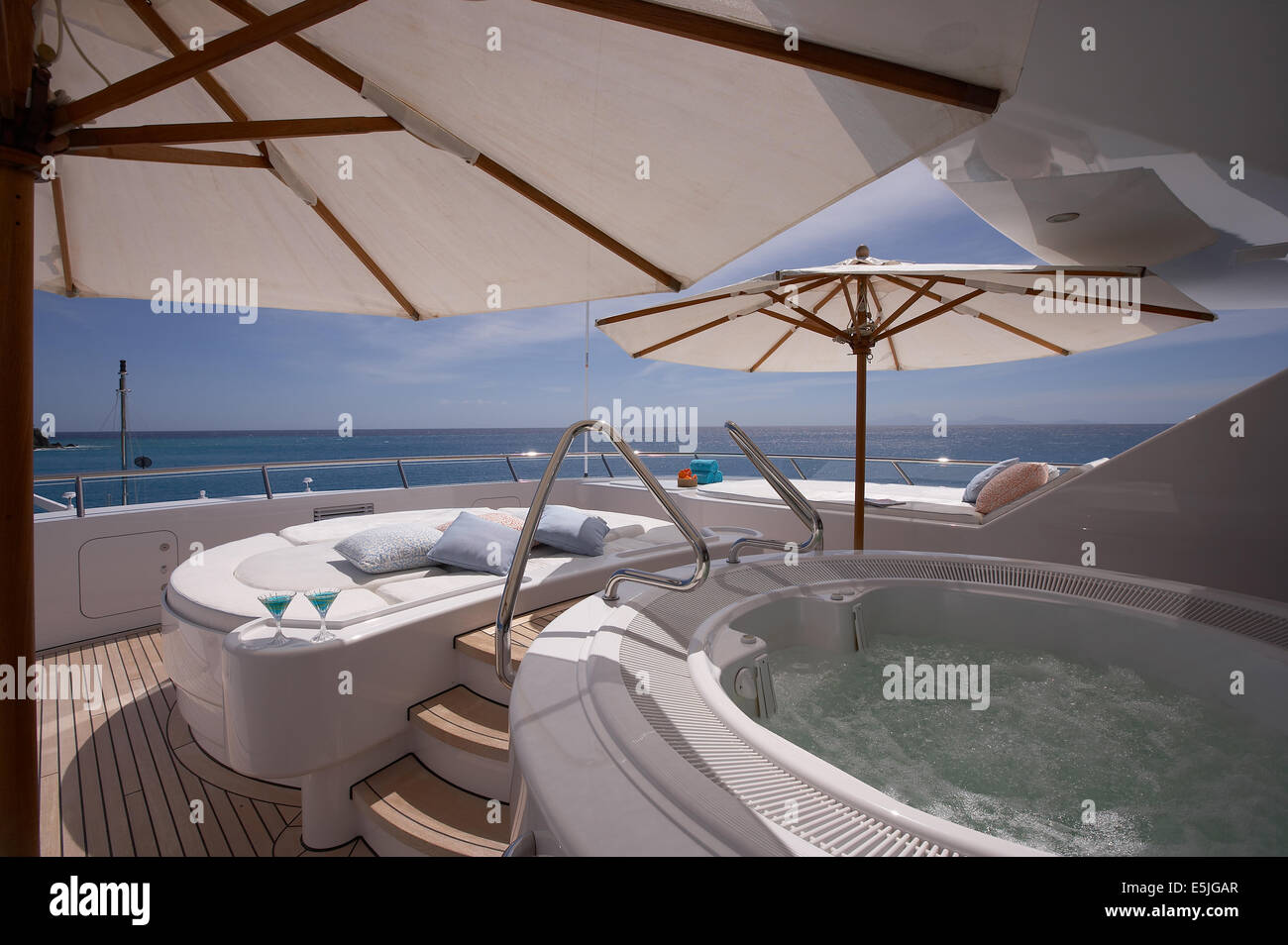 Luxurious Superyacht Deck with Jacuzzi and Ocean View Under Umbrellas ...