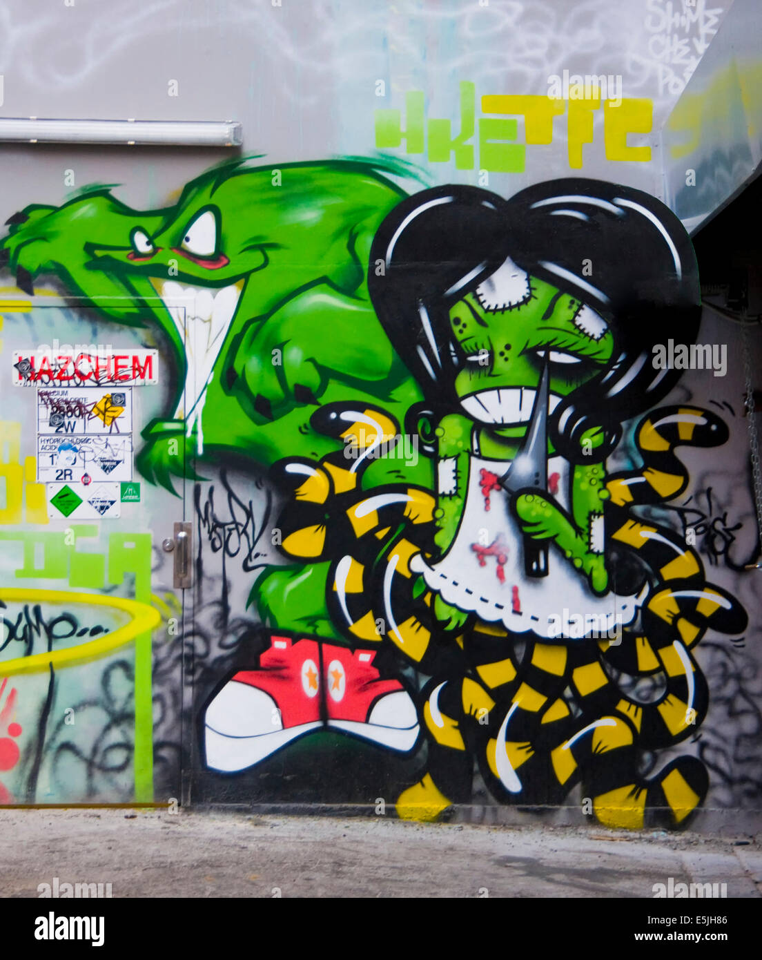 Colorful graffiti in back alley of downtown, depicts a green monster ...