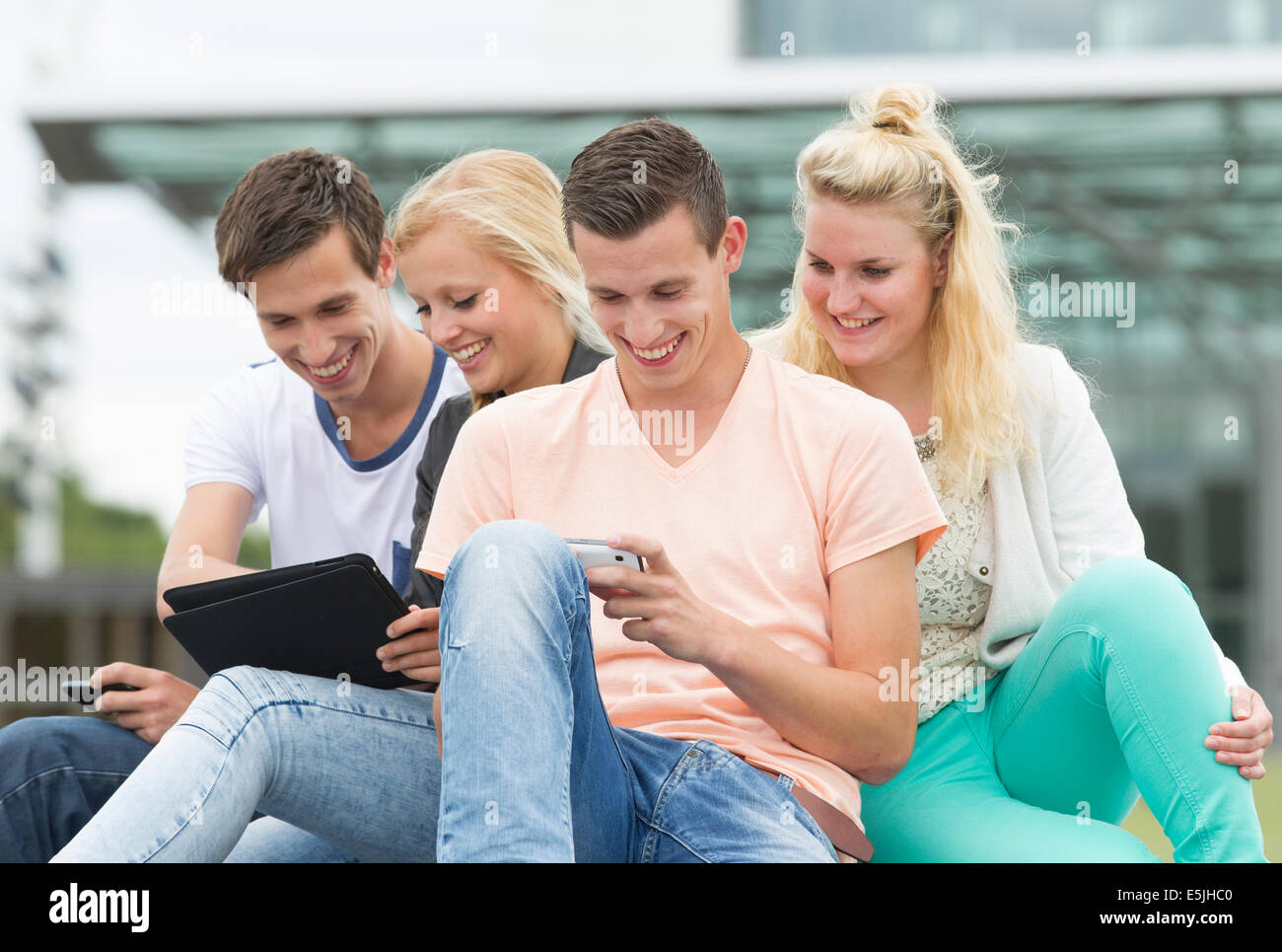 Students sitting together Stock Photo - Alamy