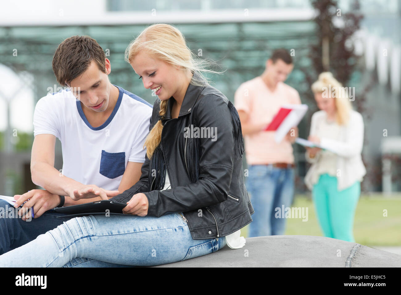Students sitting together Stock Photo - Alamy