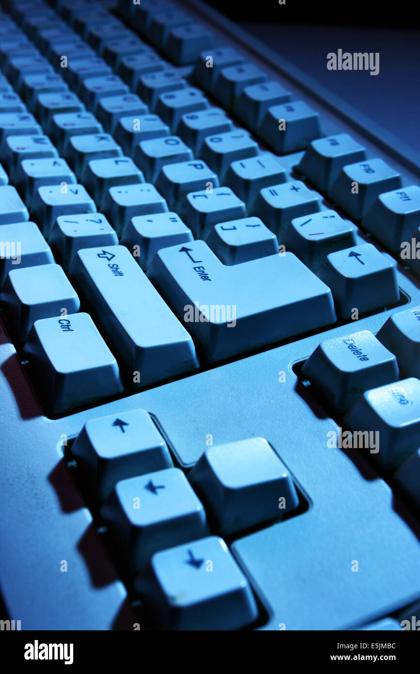 Keyboard close-up in blue light, may be used as background Stock Photo ...