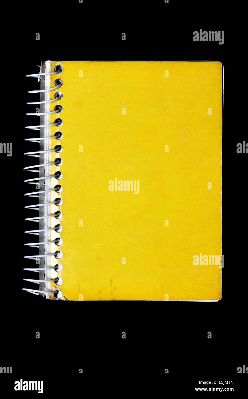 Yellow notebook close-up over black background Stock Photo - Alamy