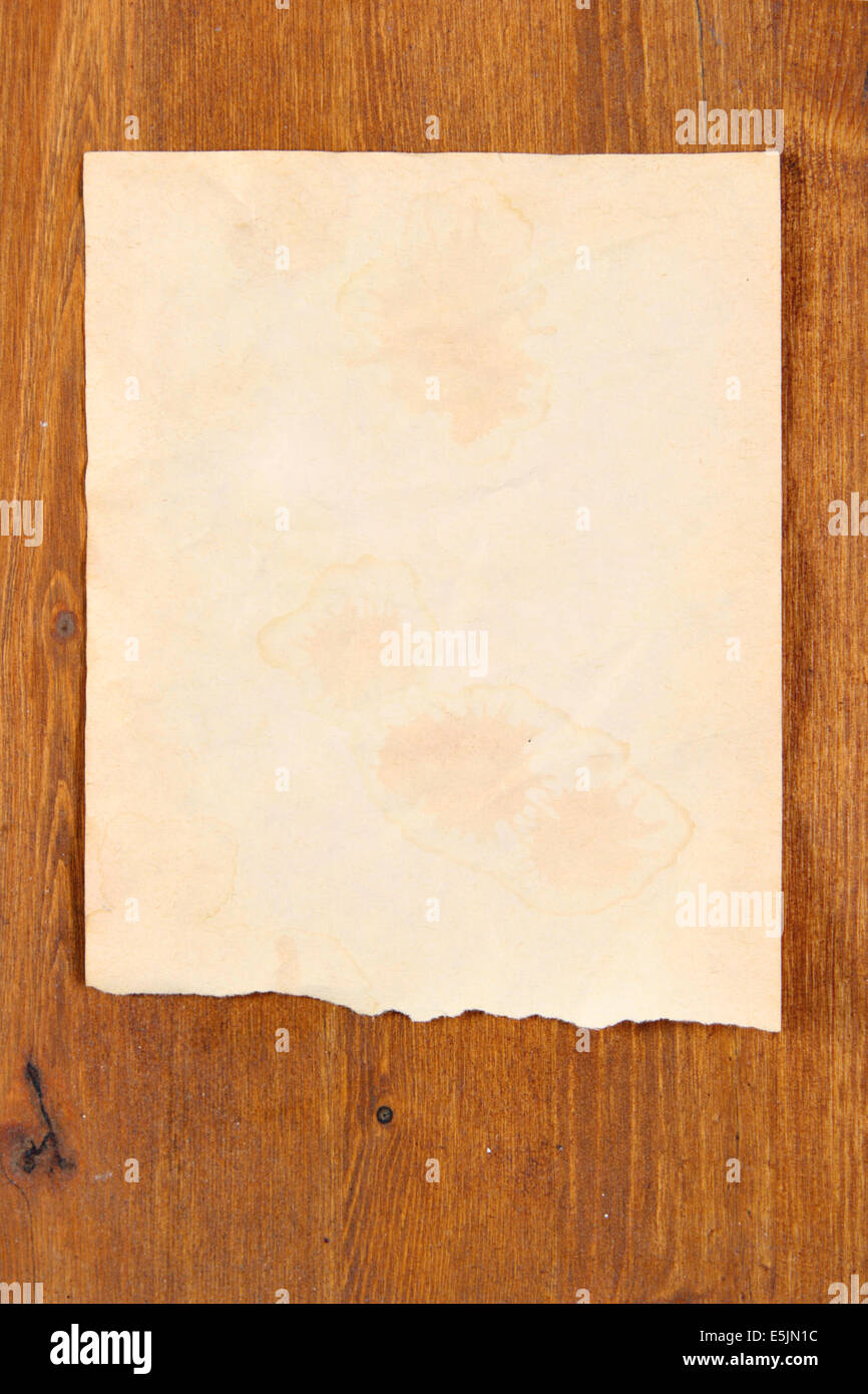Old paper scrap over wooden background Stock Photo - Alamy