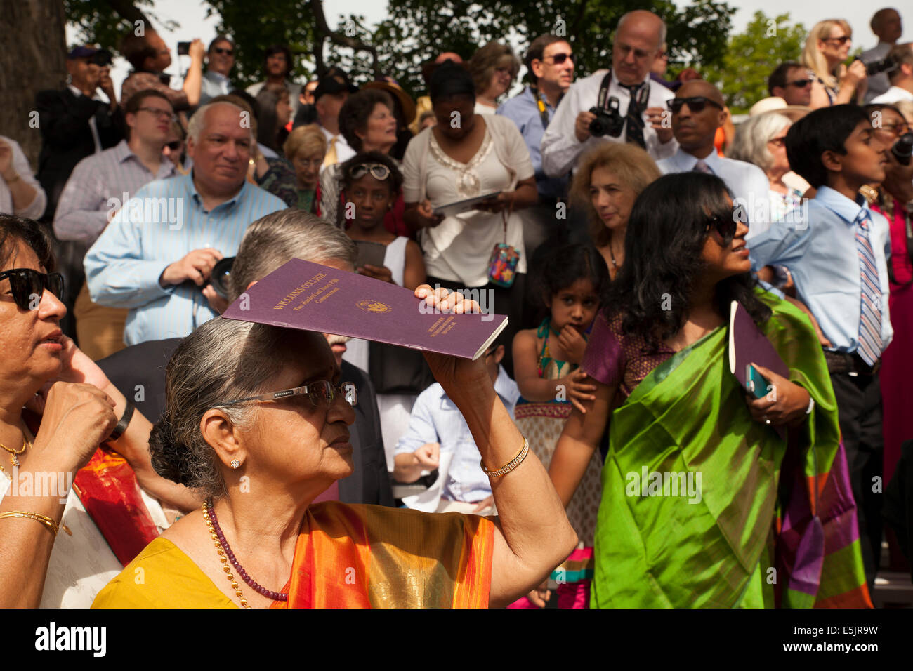 Friends and family watch graduating students parade before their ...