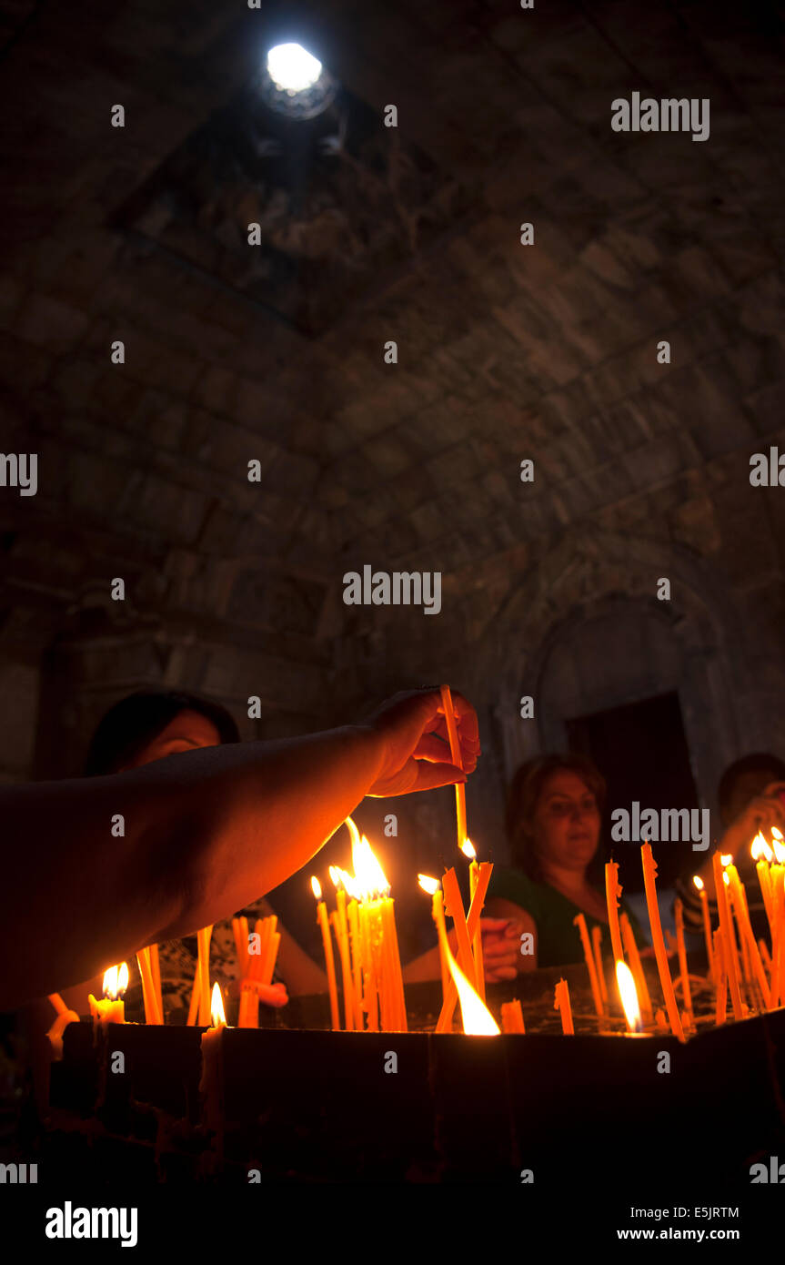 Believers lighting up candles, Noravank Monastery, Armenia Stock Photo ...