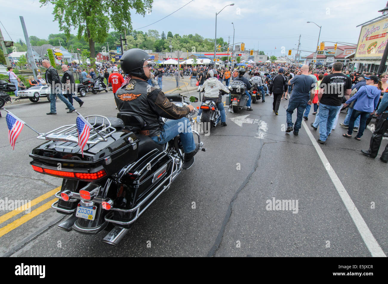 Motorcyclists line up to get a chance to pass through a heavily ...