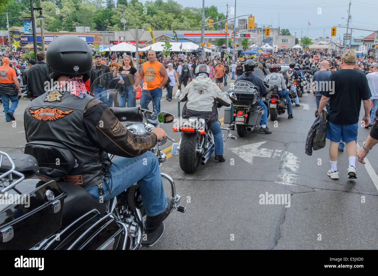 Motorcyclists line up to get a chance to pass through a heavily ...