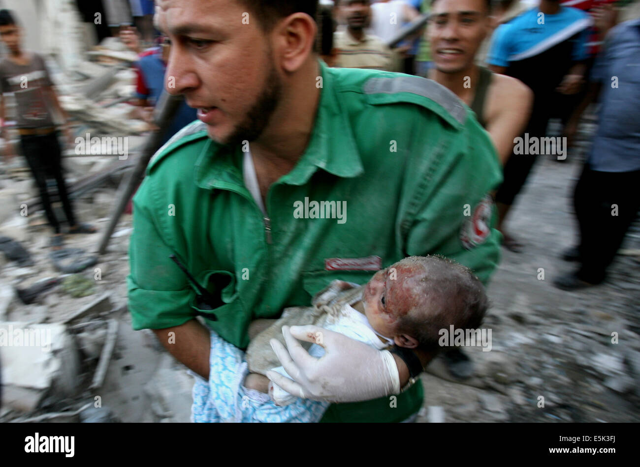 Rafah, Gaza Strip. 3rd Aug, 2014. Palestinians carry a dead infant who ...