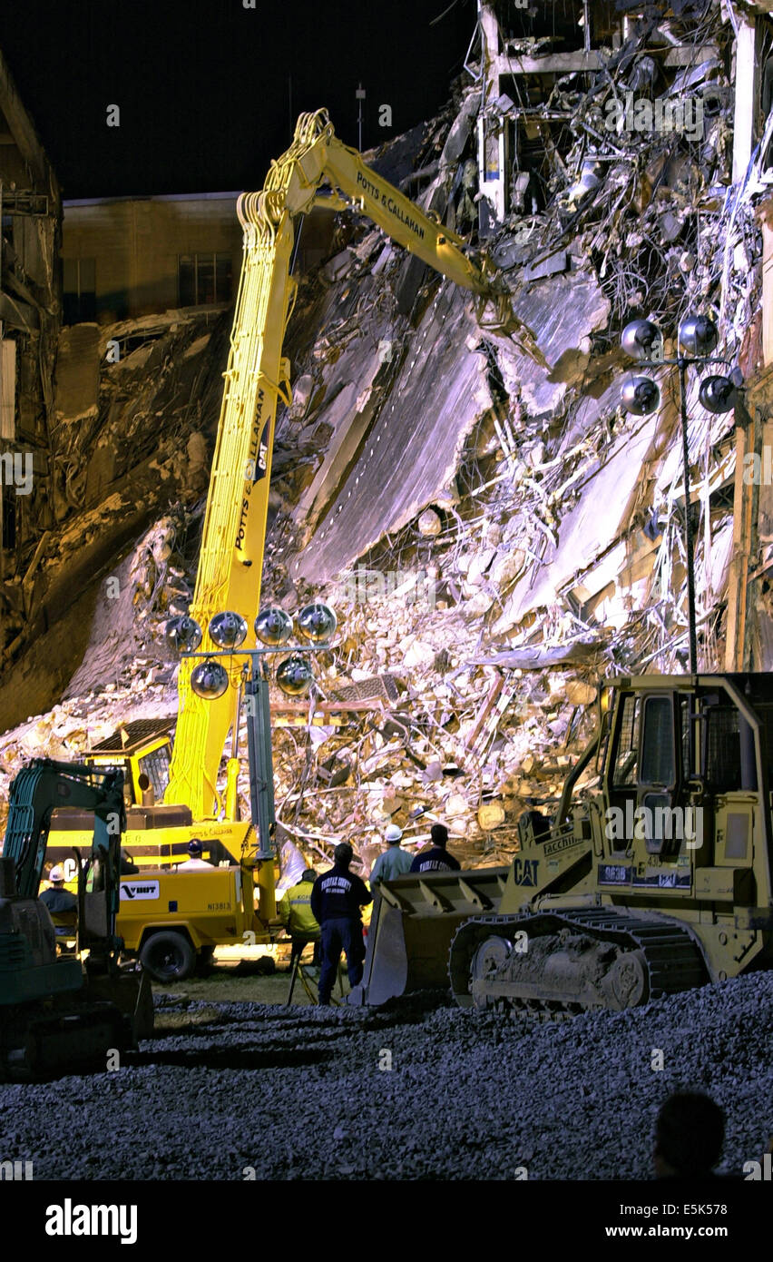 FEMA Urban Search and Rescue workers use a crane to clear rubble from ...