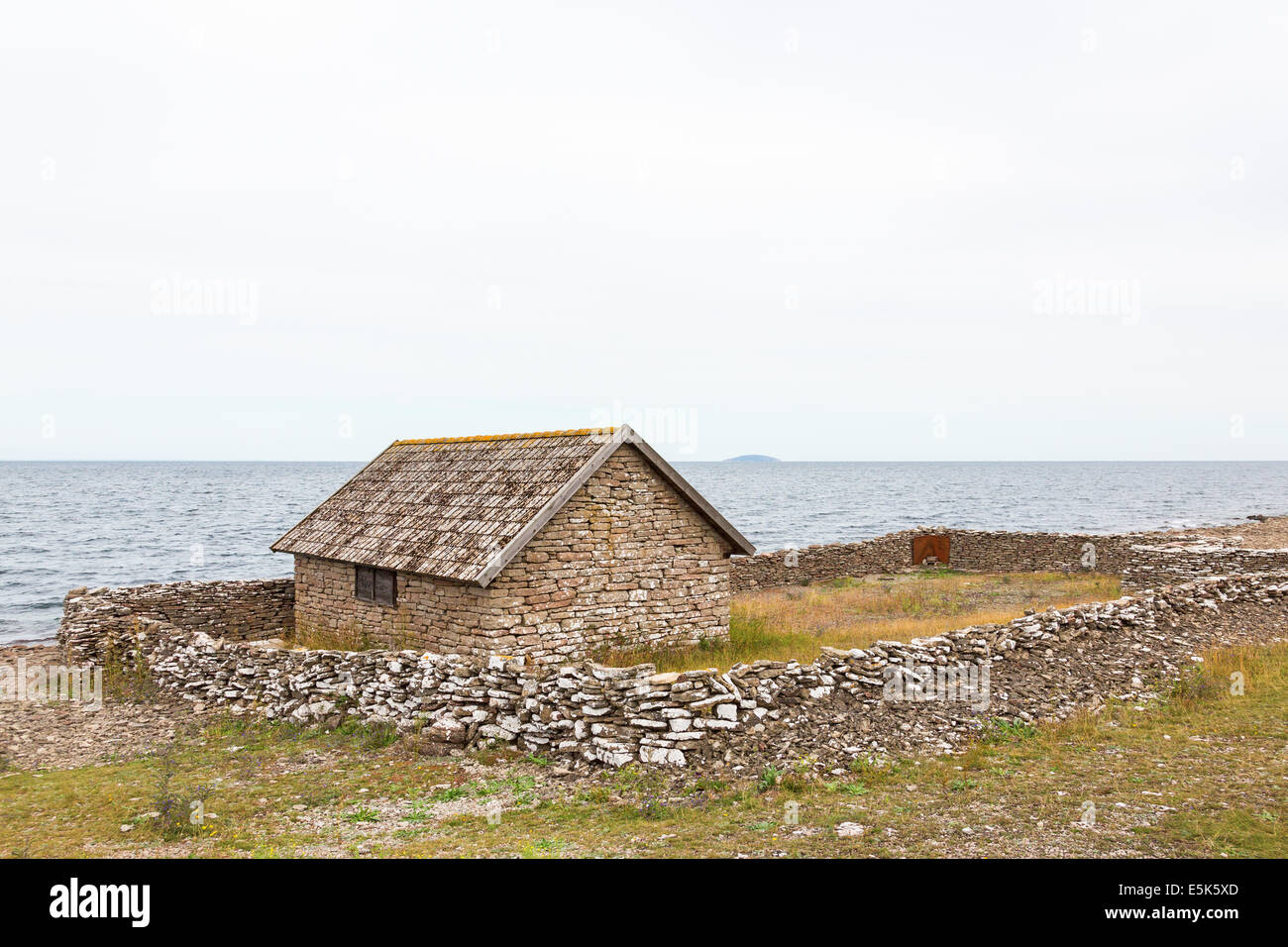 Old boathouse with stone wall on the shore Stock Photo - Alamy