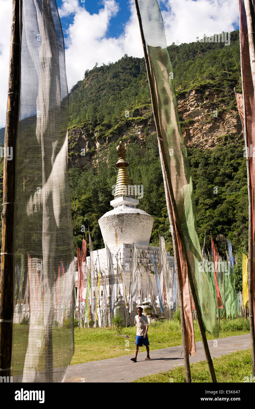 Eastern Bhutan, Lhuentse Valley Autsho, man walking past white Tibetan ...