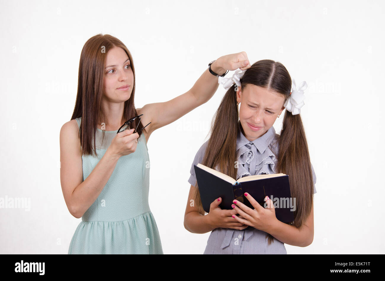 Teacher bangs his hand on the head and scolds student Stock Photo - Alamy