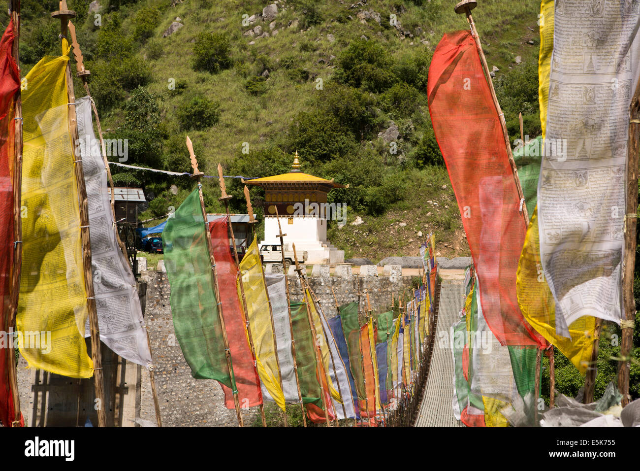 Eastern Bhutan, prayer flags lining suspension footbridge across Kuri ...