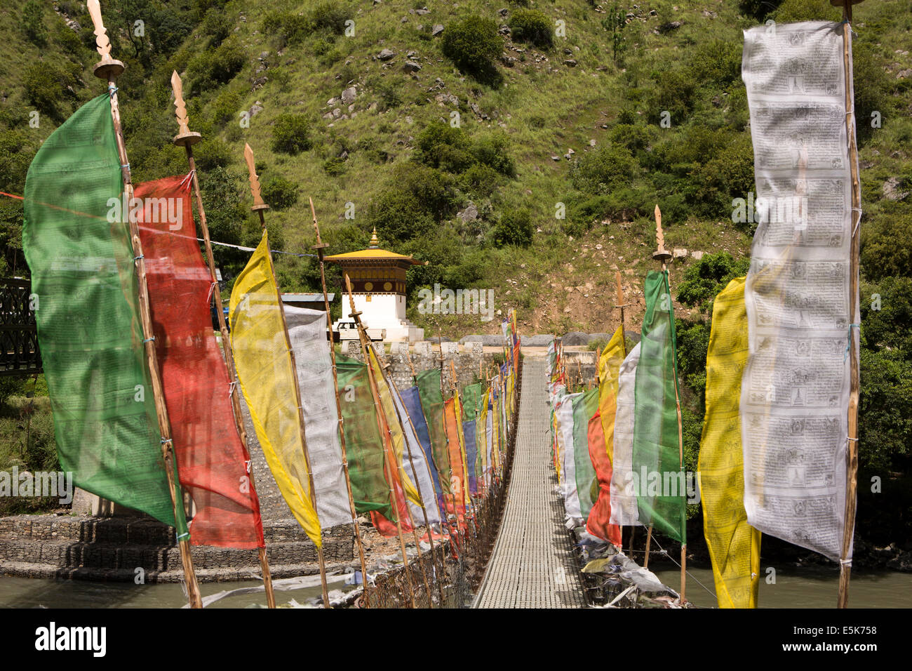 Eastern Bhutan, prayer flags lining suspension footbridge across Kuri ...