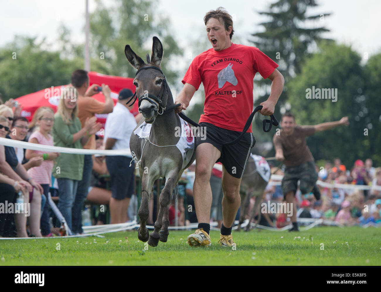 Hersbruck, Germany. 03rd Aug, 2014. Participants run with their donkeys ...