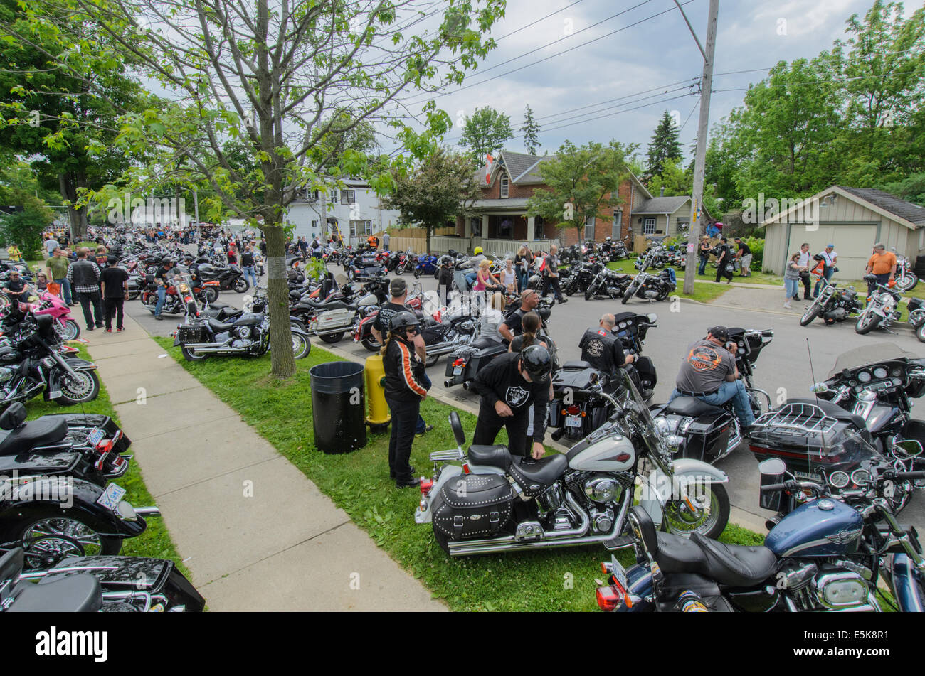 Motorcycles are parked everywhere except the sidewalk during the ...