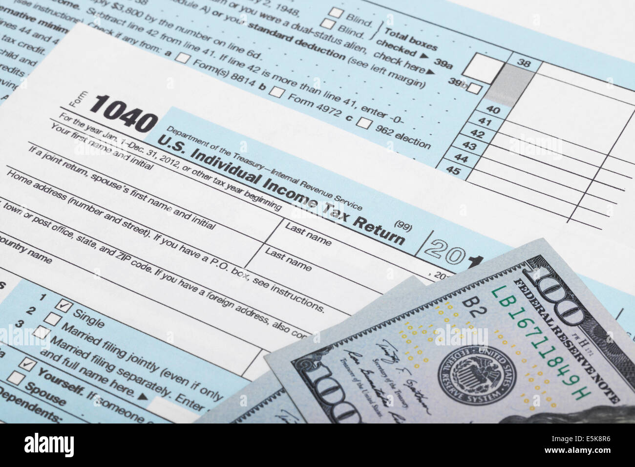 USA 1040 Tax Form with two 100 US dollar bills over it - studio shoot ...