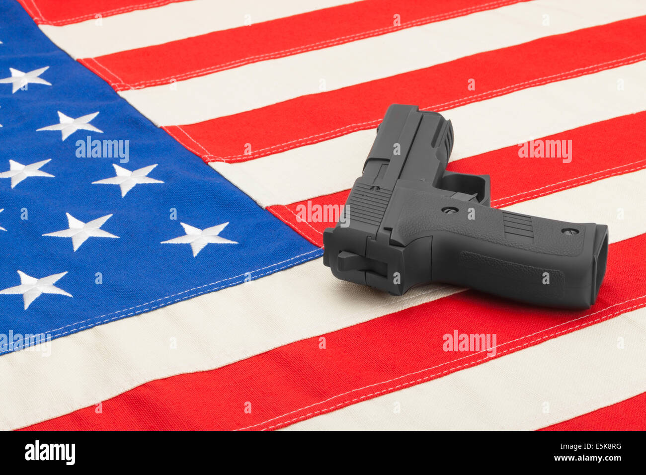 Gun laying over USA flag - studio shoot Stock Photo - Alamy