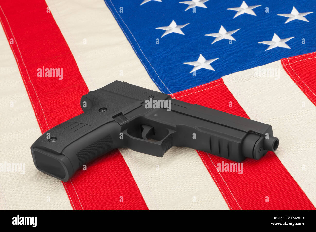 Handgun laying on USA flag - studio shoot Stock Photo - Alamy