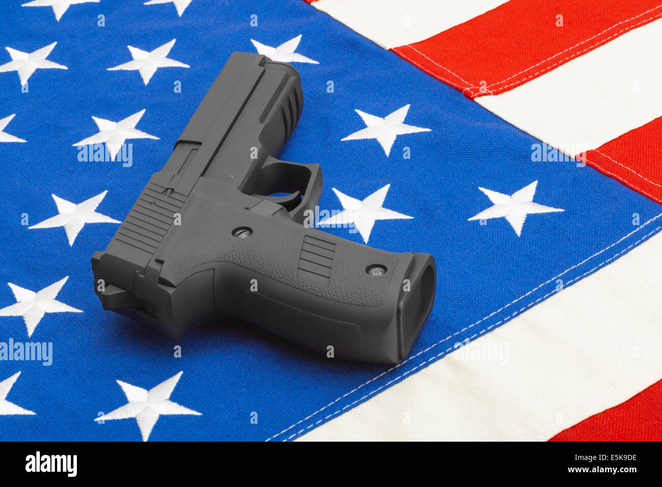 Handgun over USA flag - studio shoot Stock Photo - Alamy