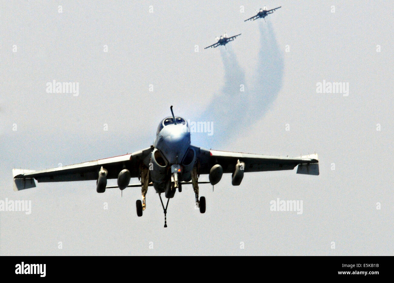 A US Navy EA-6B Prowler aircraft prepares to land as two F/A-18E Super ...