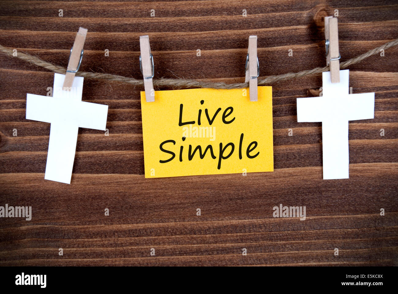 The Words Live Simple on a Yellow Tag on a Line with two white Crosses ...