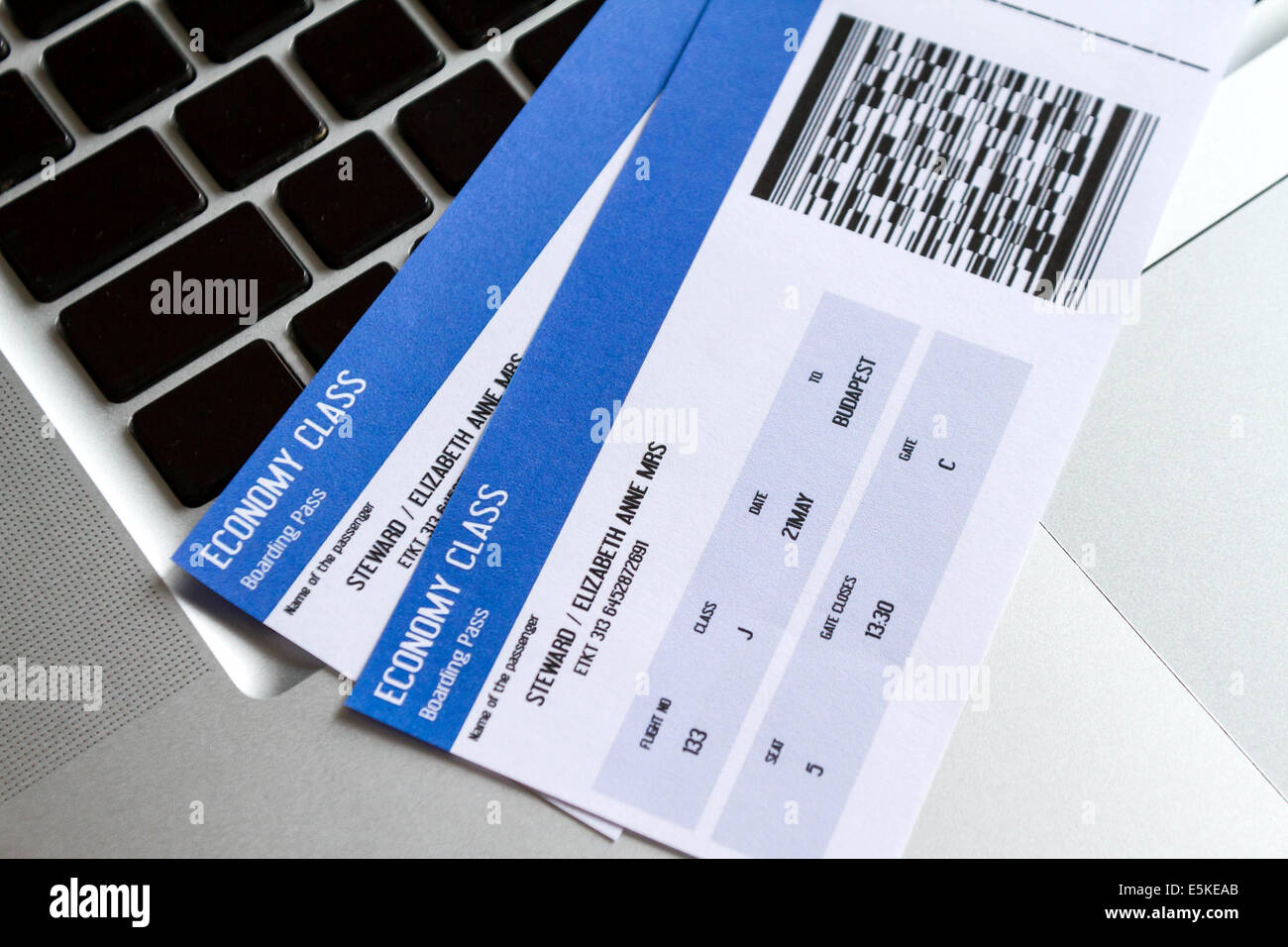 Airline tickets over the keyboard of a laptop Stock Photo - Alamy