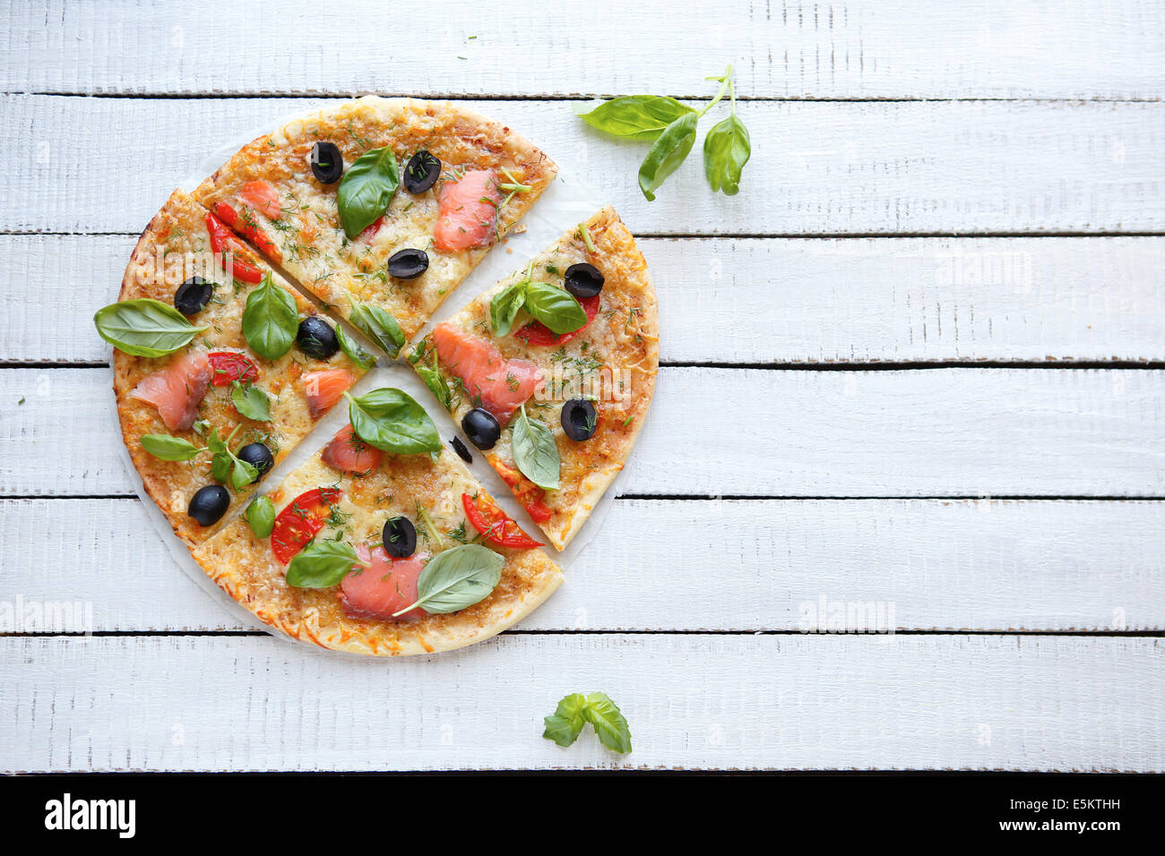 pizza with cheese, smoked salmon and olives, top view Stock Photo - Alamy