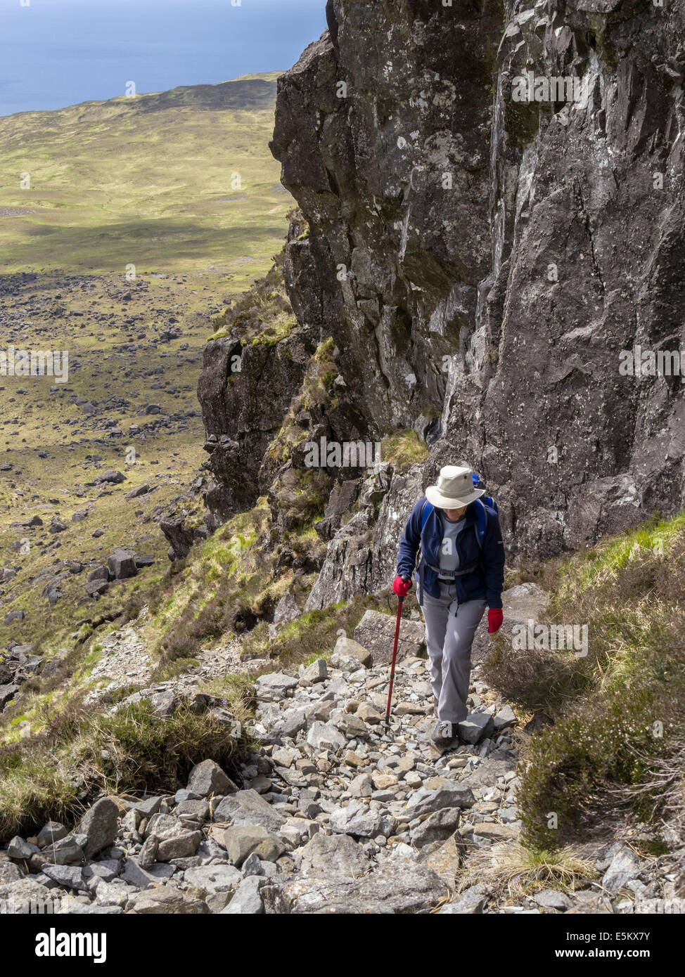 Lone female hill walker high on ascent to Coir' a' Ghrunnda in the ...