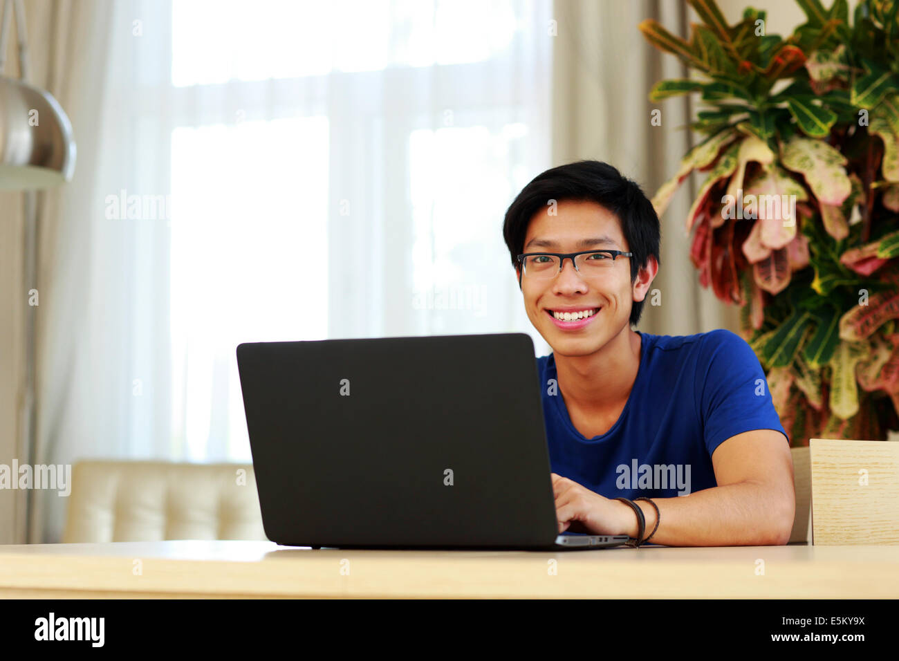 Happy asian man sitting hi-res stock photography and images - Alamy