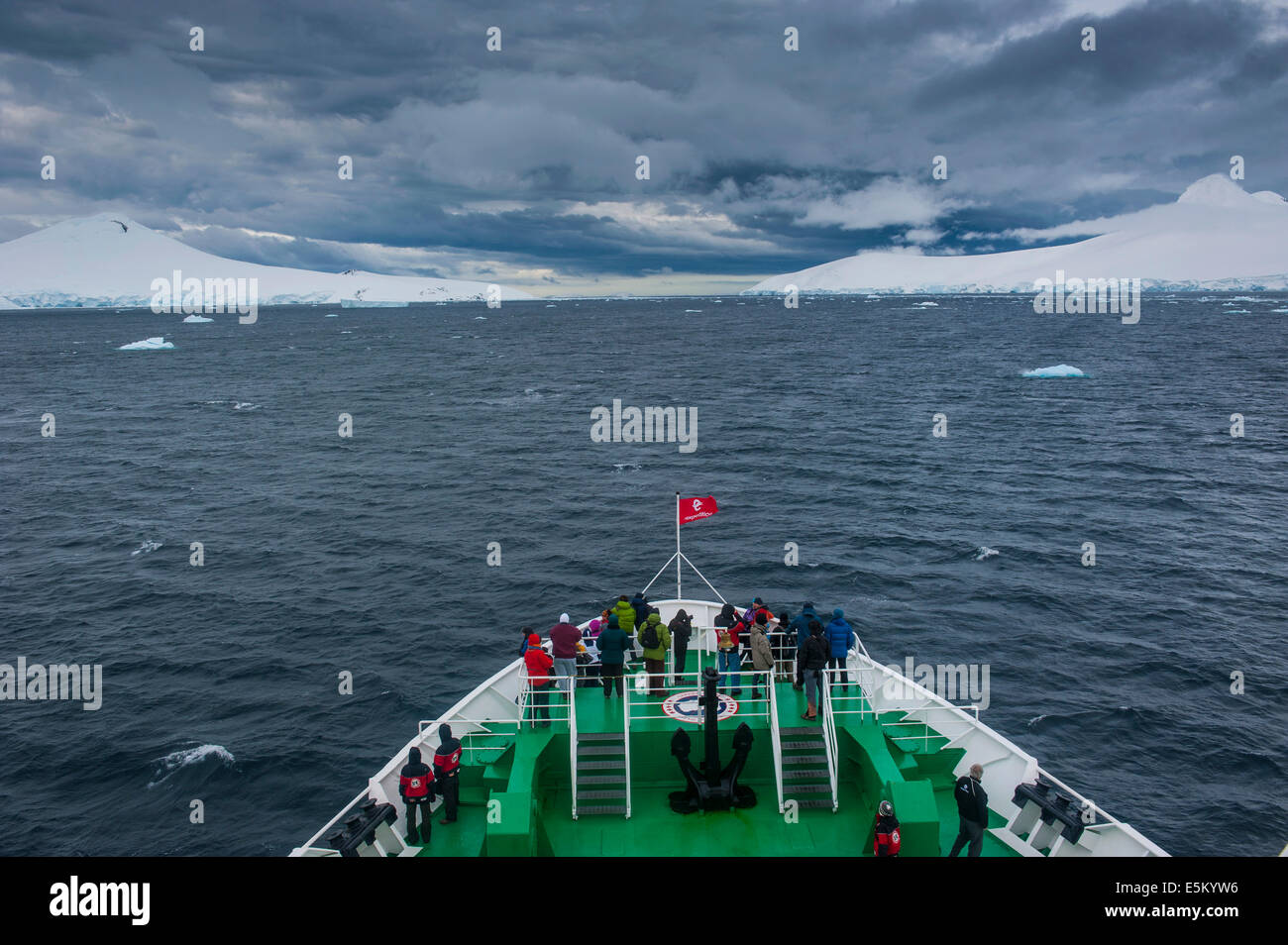 Ship heading towards glaciers and dark clouds, near Port Lockroy ...