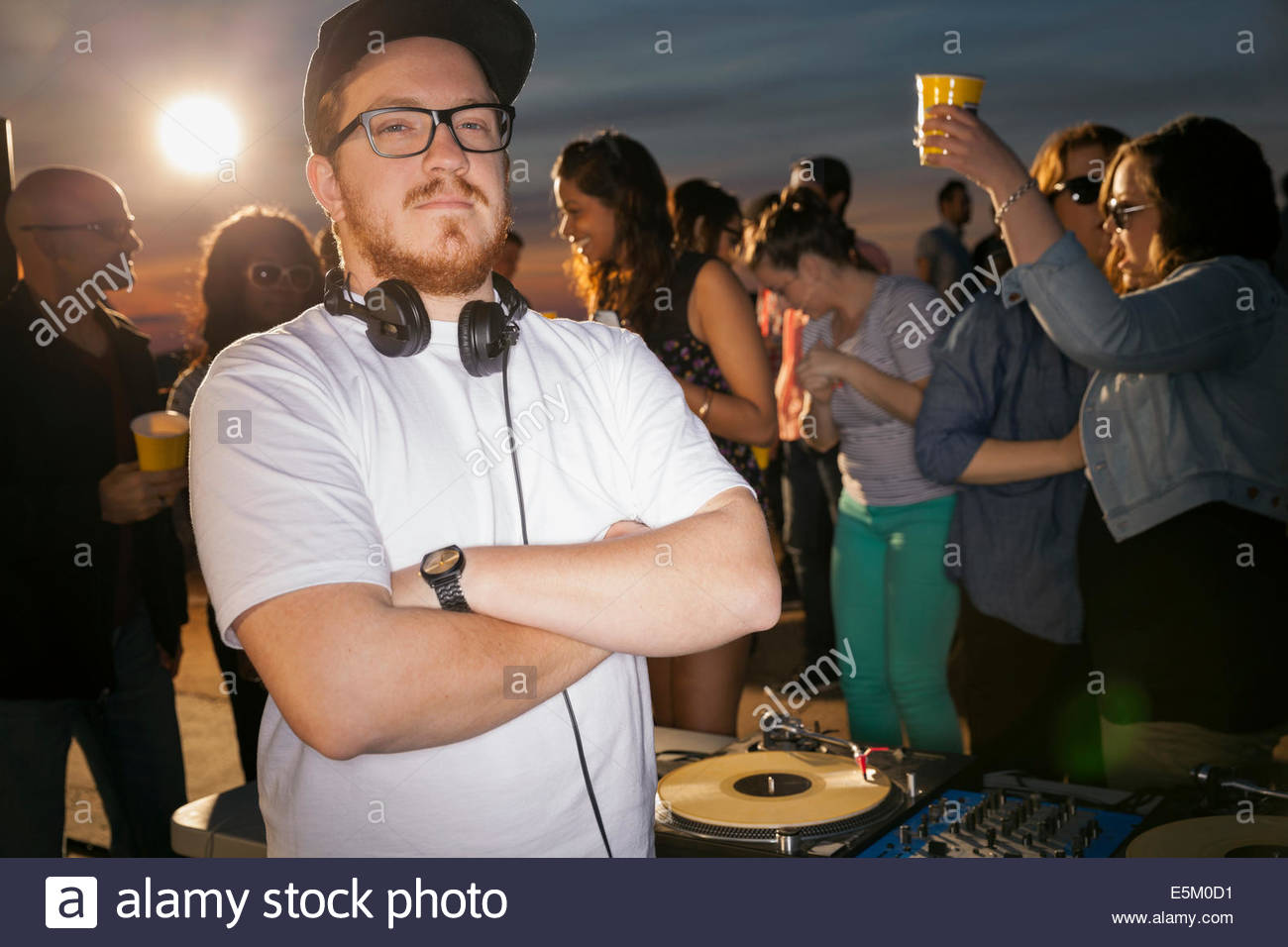 Portrait of confident DJ at rooftop party Stock Photo - Alamy
