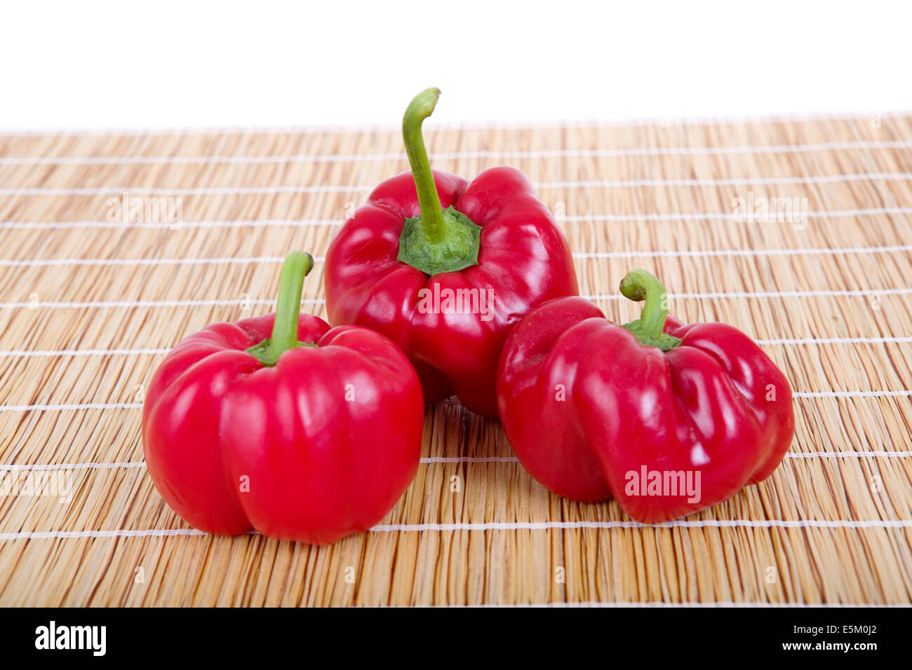 three red peppers, isolated on white background Stock Photo - Alamy