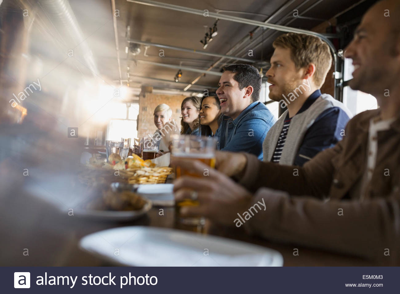 People sitting at bar in pub Stock Photo - Alamy