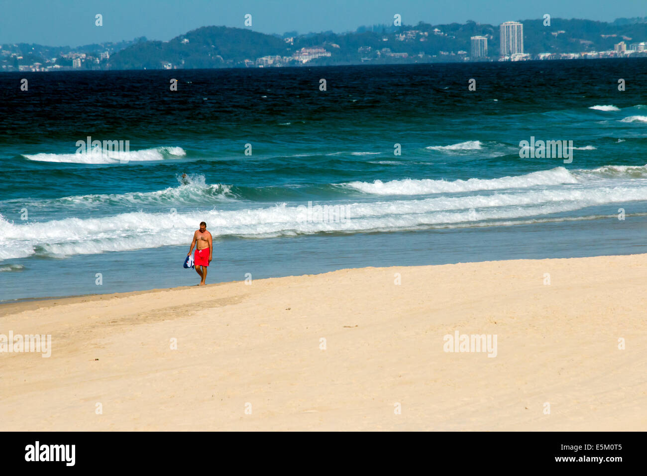 Man walking on beach in hi-res stock photography and images - Alamy