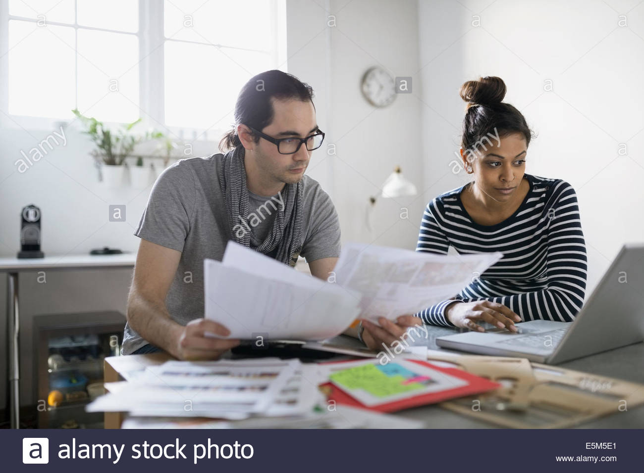 Creative business people reviewing paperwork in office Stock Photo - Alamy