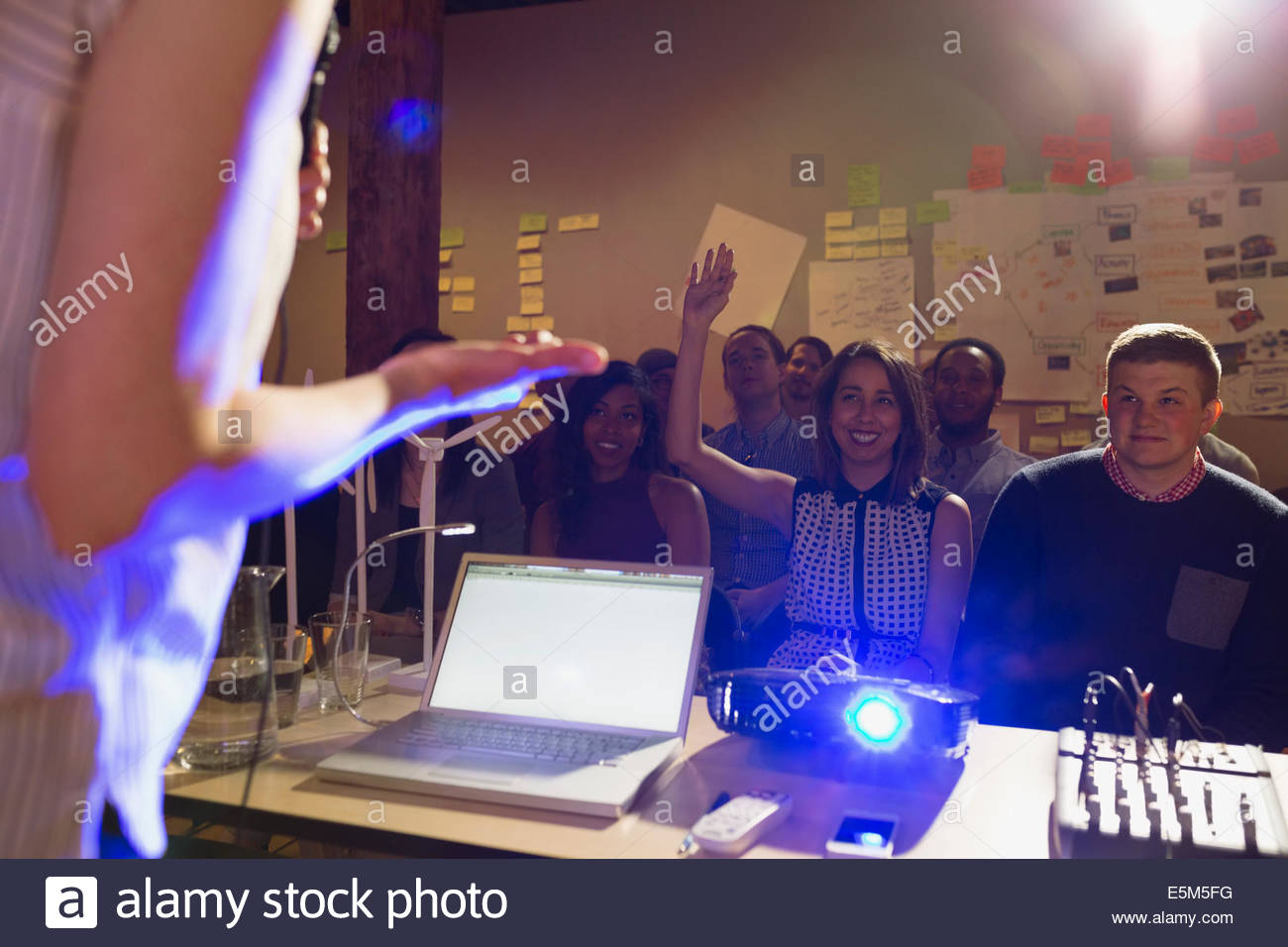 Audience member raising hand in presentation Stock Photo - Alamy