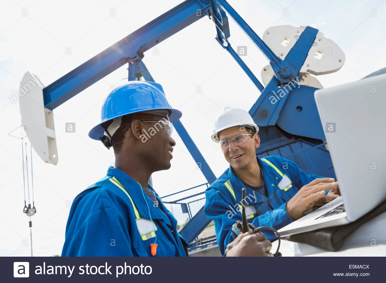 Co workers using laptop hi-res stock photography and images - Alamy