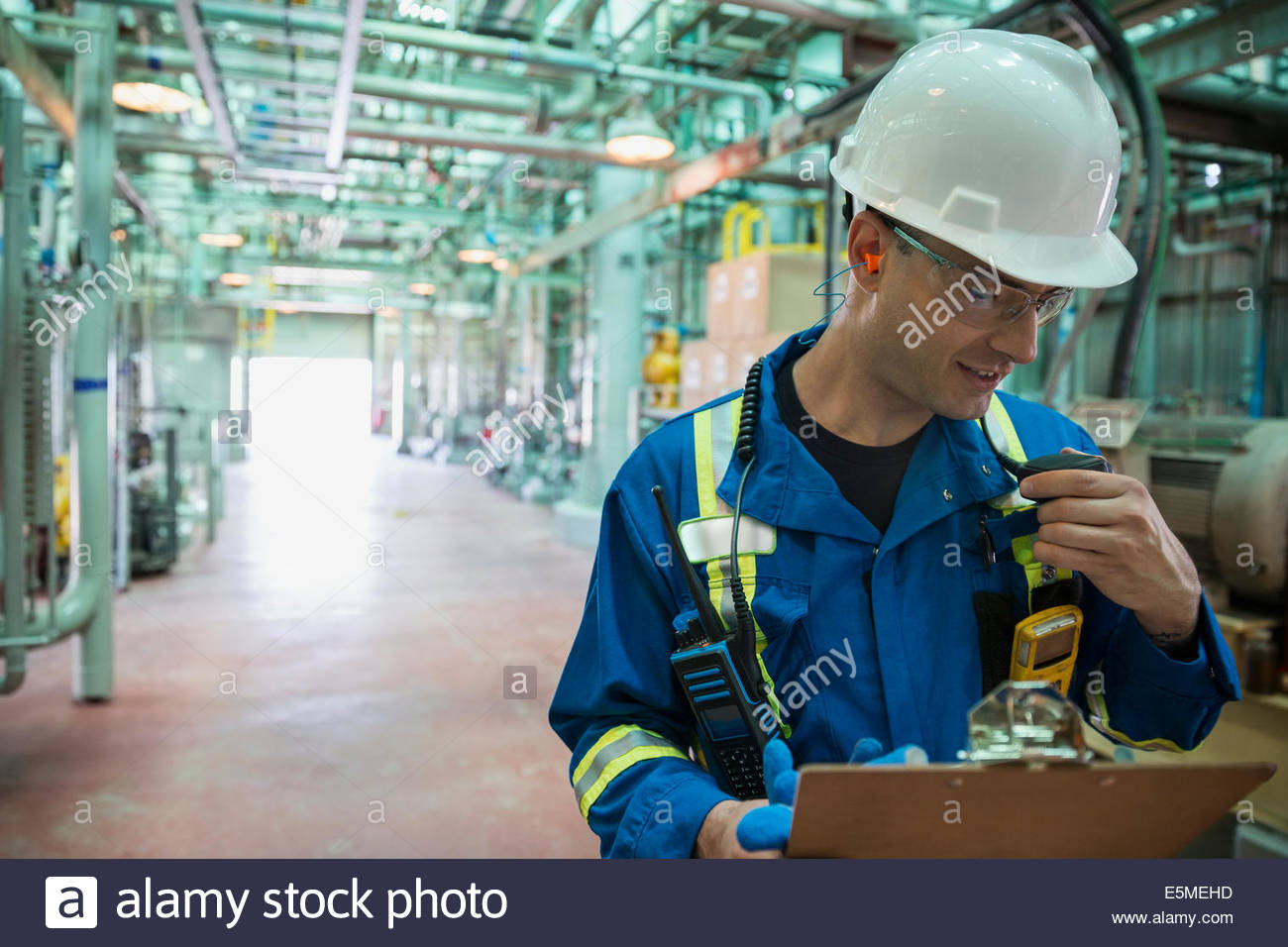 Male worker using walkie-talkie in gas plant Stock Photo - Alamy