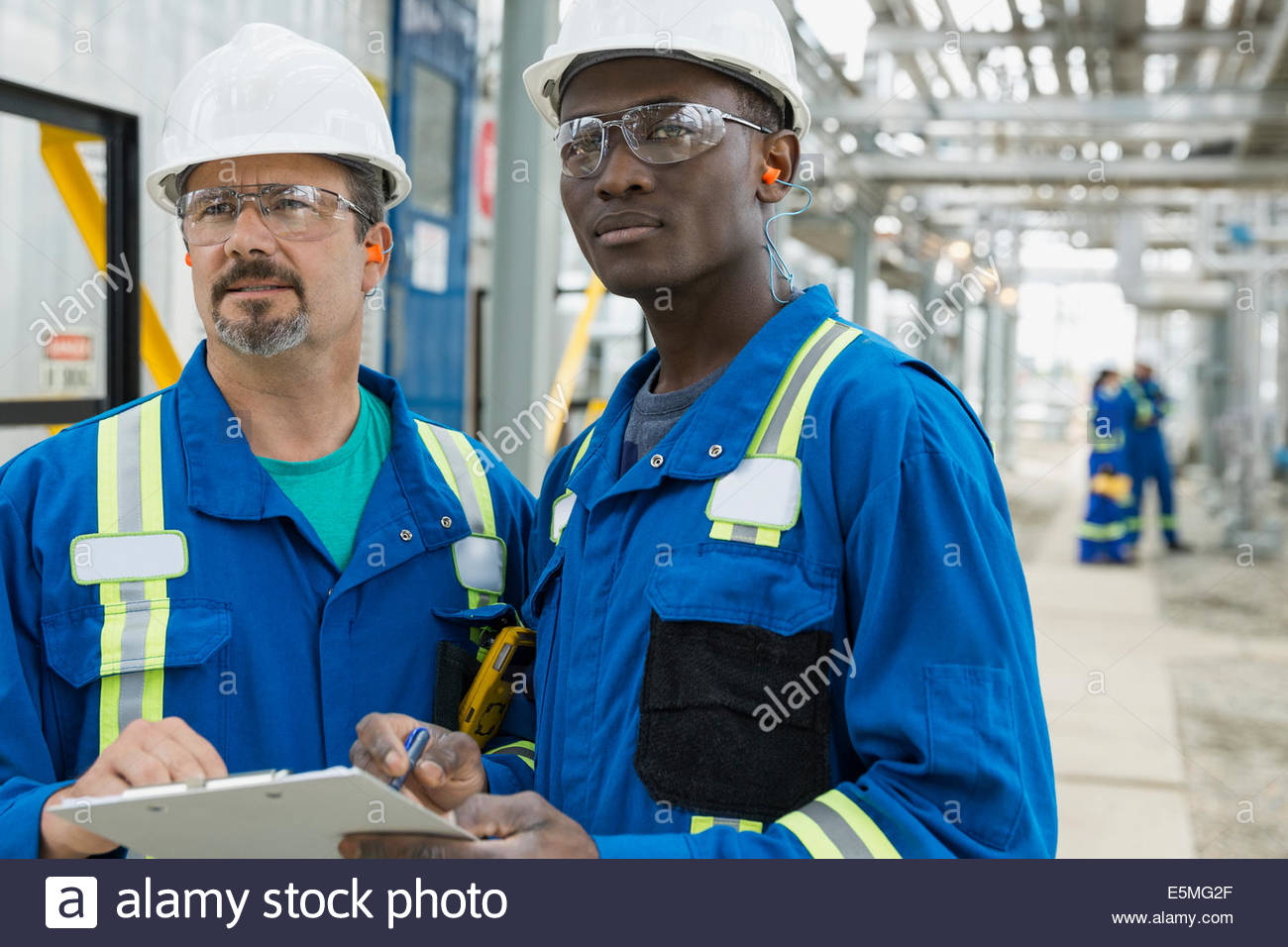 Male workers reviewing paperwork at gas plant Stock Photo - Alamy Male workers reviewing paperwork at gas plant Stock Photo - Alamy