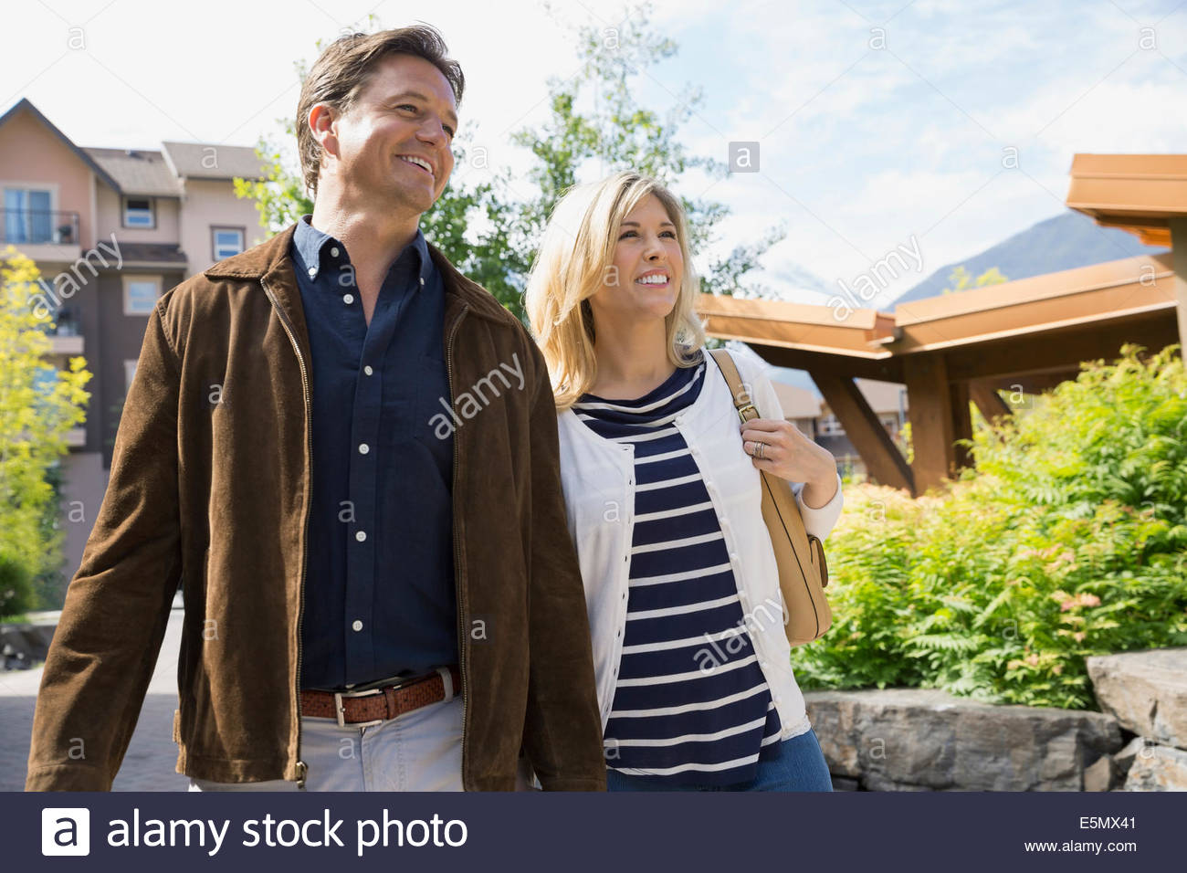 Couple walking outside hotel Stock Photo - Alamy
