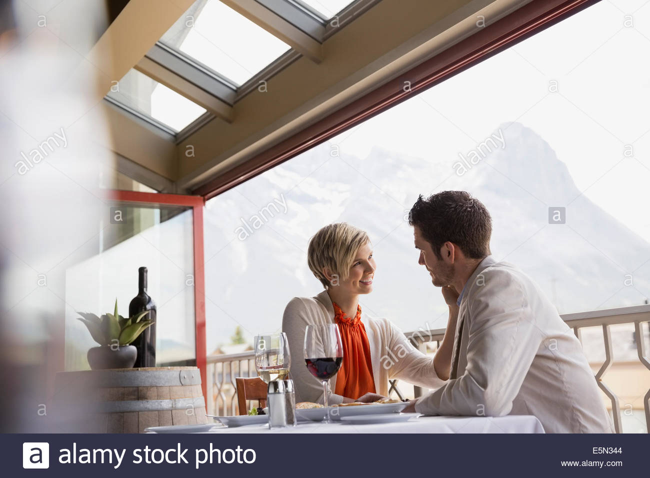 Romantic couple at restaurant table on balcony Stock Photo - Alamy